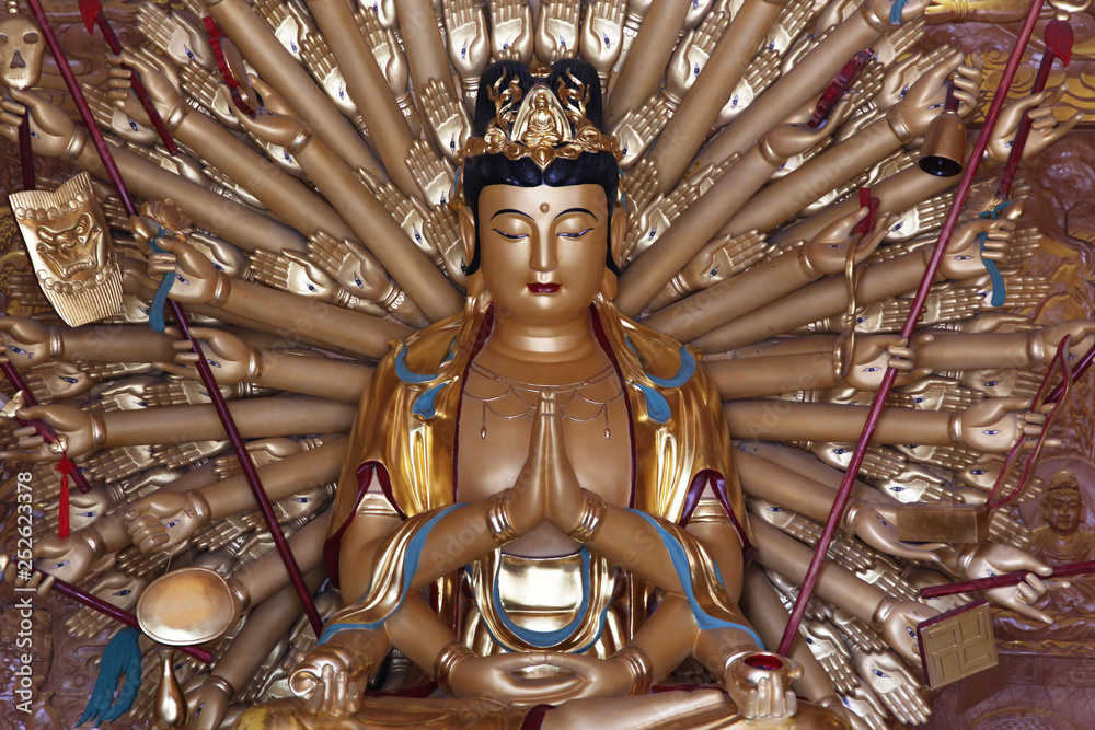 Buddhist deity statue with many arms Stock Photo | Adobe Stock
