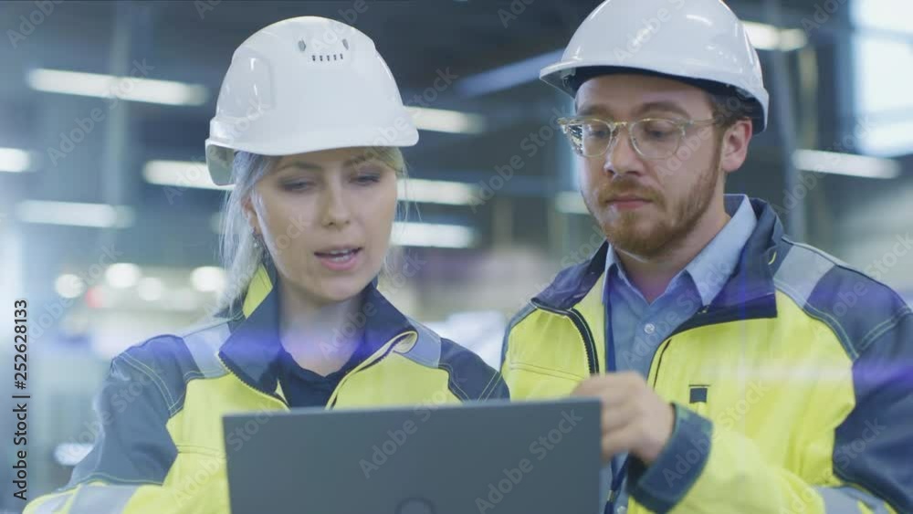 Stockvideo At the Factory: Male Mechanical Engineer Holds Component and ...