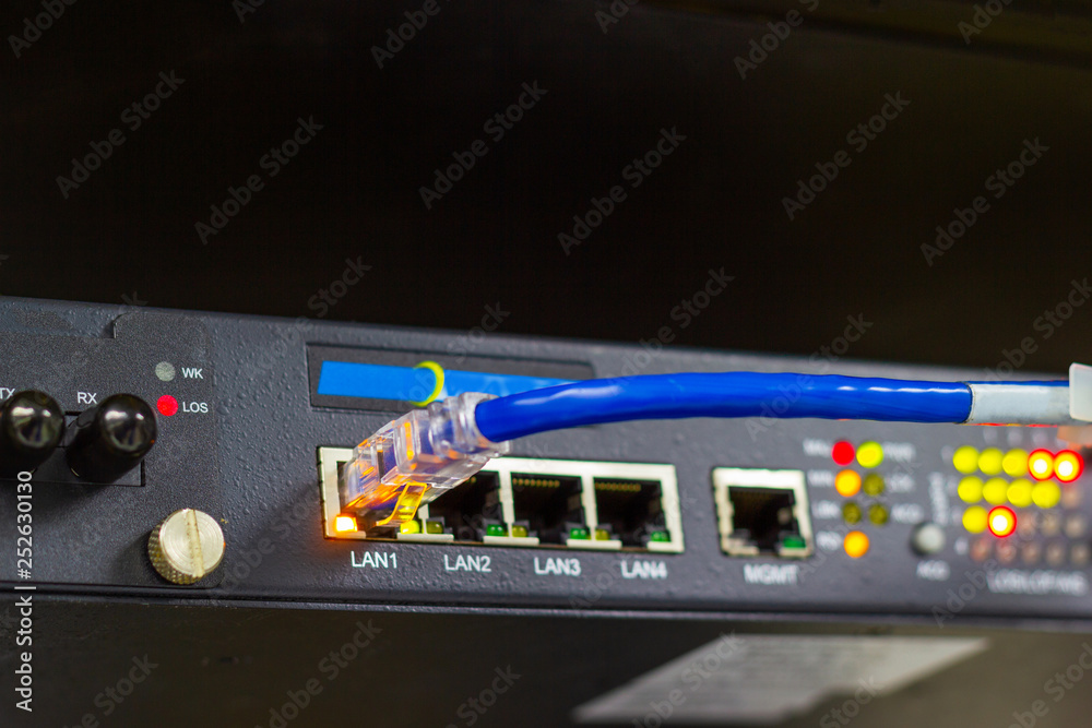 Network switch in rack, network cables connect SFP module port in the ...