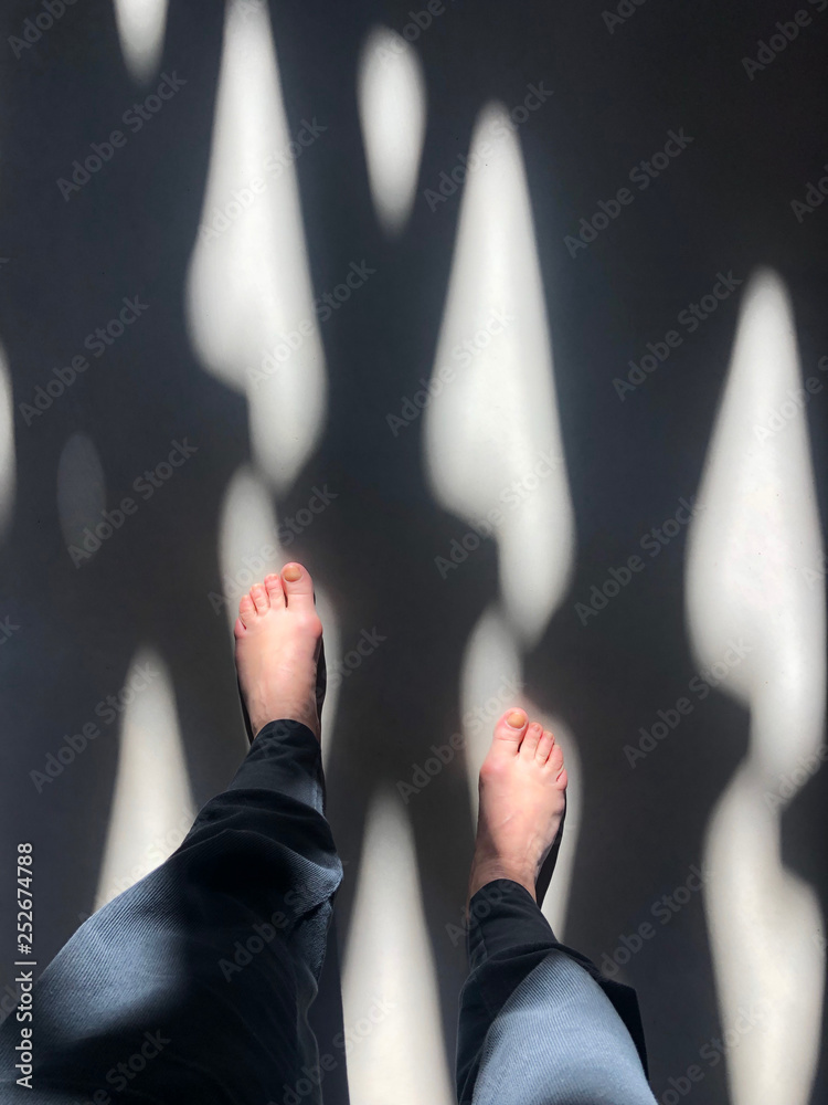 female human feet between light and shadow Stock Photo | Adobe Stock