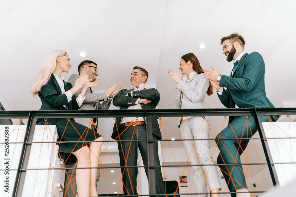 Fotografia do Stock: Bottom view of colleagues in formal wear clapping ...