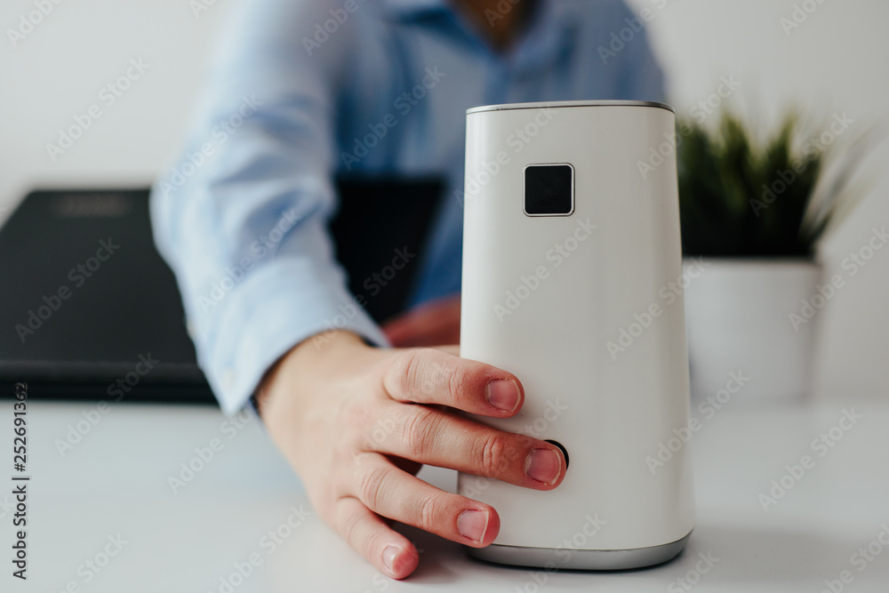 Ionizer stands on a white shelf on a white background. Air purifier at ...