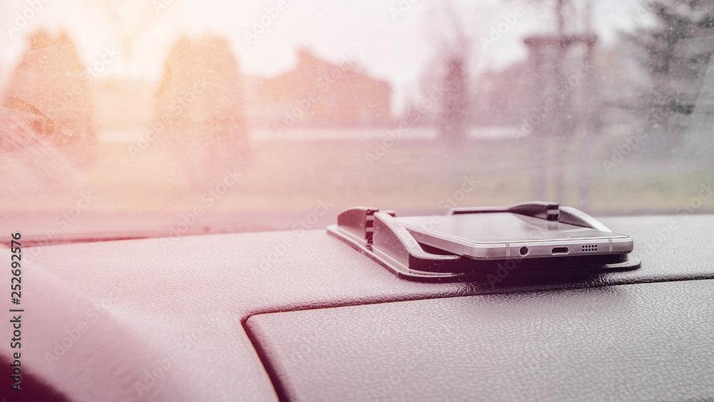 Phone on the pad in the car. The concept of laying the phone in the car ...