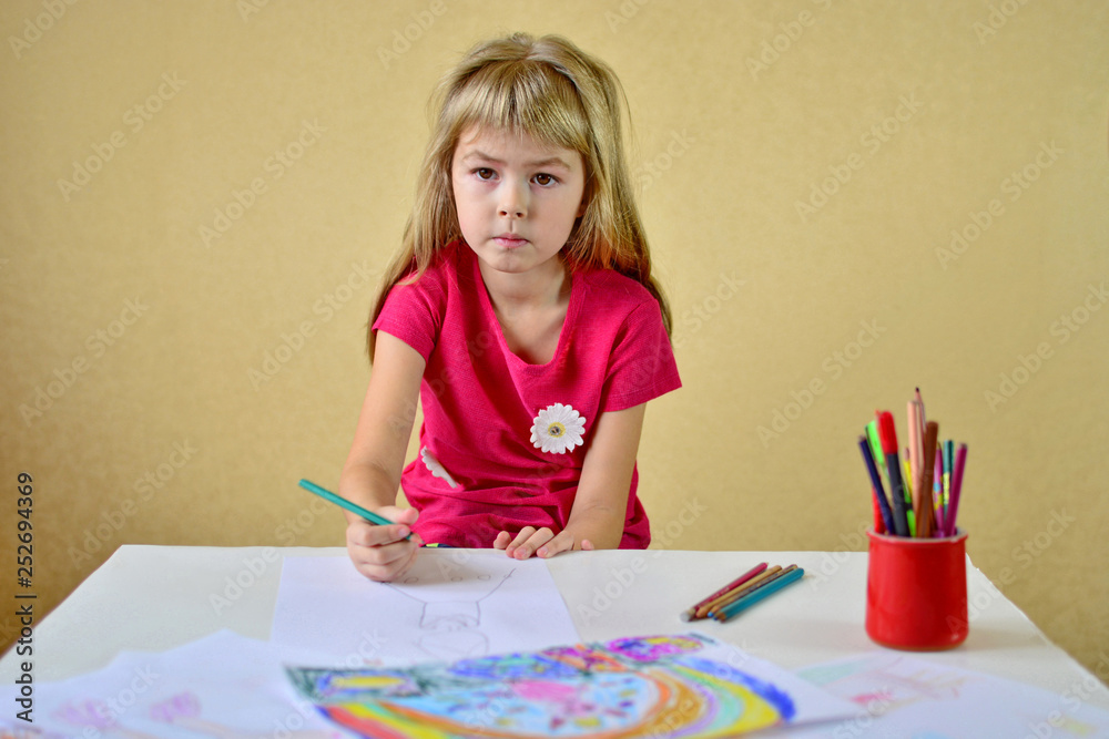 Little girl draws. Beautiful little girl. Drawing lesson. The child ...