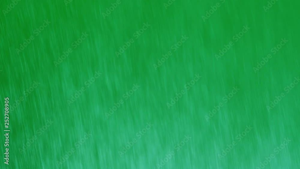 Rain falling on the green screen - chroma key background. 4K - Ultra HD ...