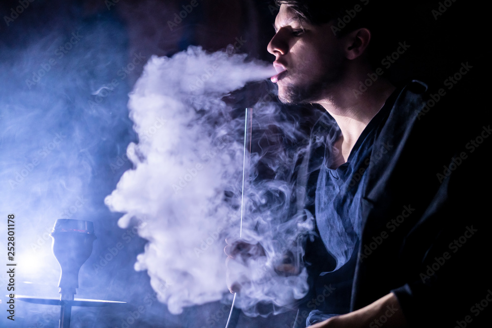person smoke hookah in dark place b Stock Photo | Adobe Stock