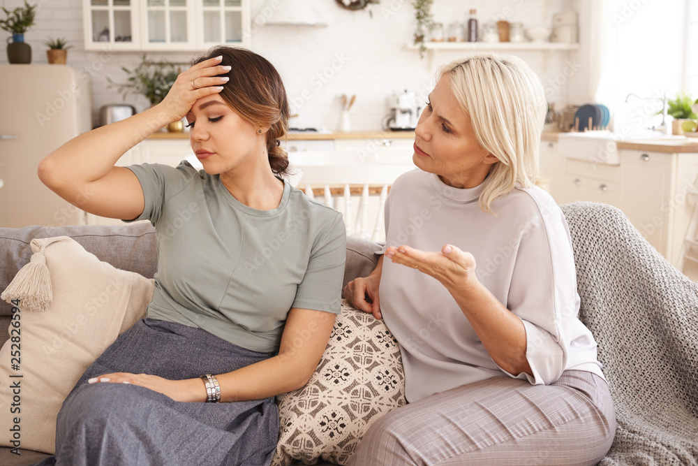 Picture of worried mature blonde woman trying to have conversation with ...