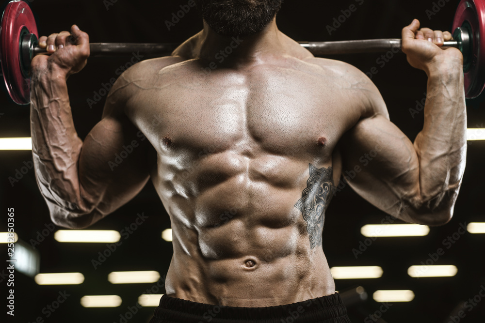 Handsome strong athletic men pumping up muscles workout barbell squat ...