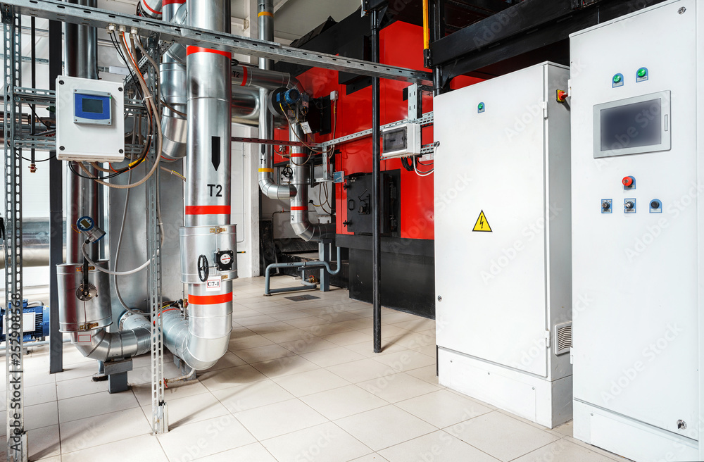 boiler room with chip boiler, fuel supply system pipes and control ...