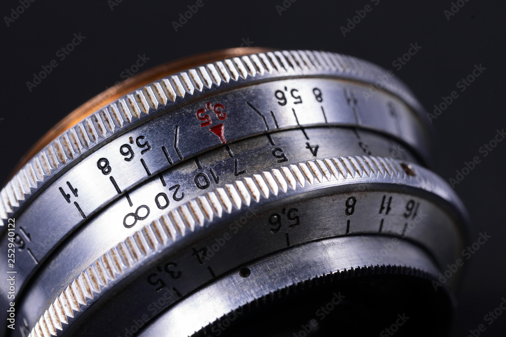 Old vintage lens scales symbols closeup view. Photo with blurred gray ...