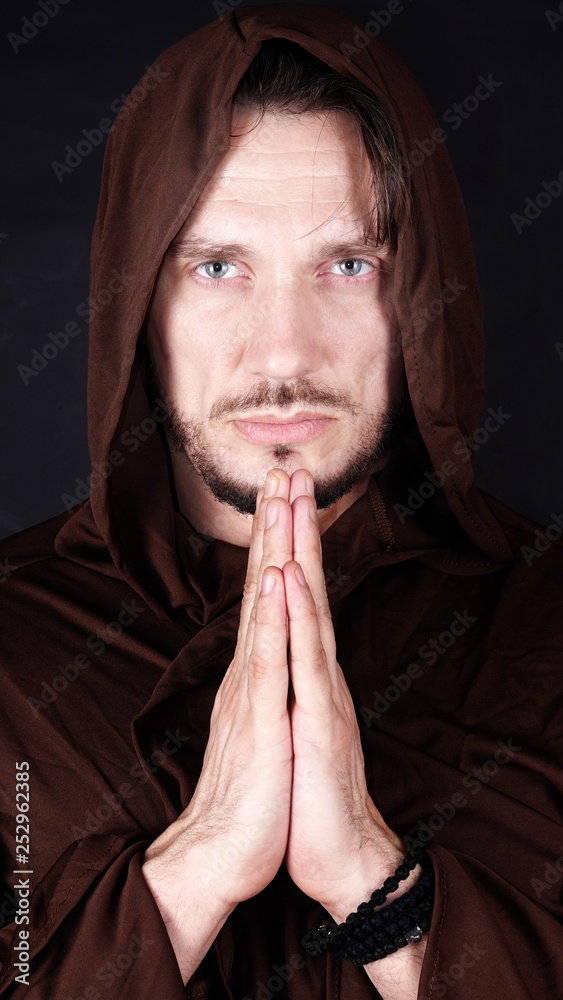 Photo & Art Print Man in monk hood is praying, Uros Petrovic