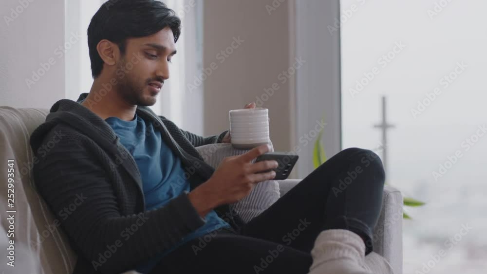 happy young man using smartphone browsing online reading social media ...