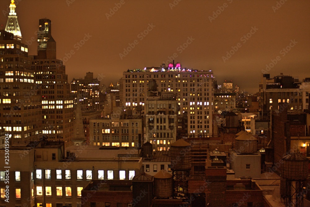 Illuminated Manhattan skyline at night time with skyscrapers, high-rise ...