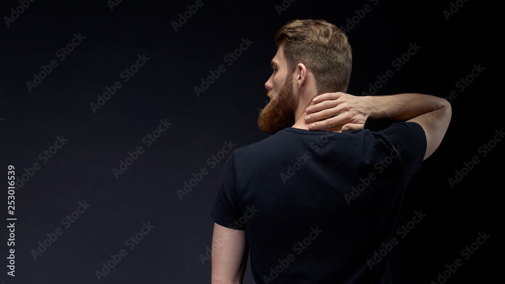 Man turned his back and put hand around neck Stock Photo | Adobe Stock