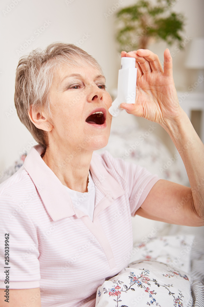 Senior woman using inhaler Stock Photo | Adobe Stock