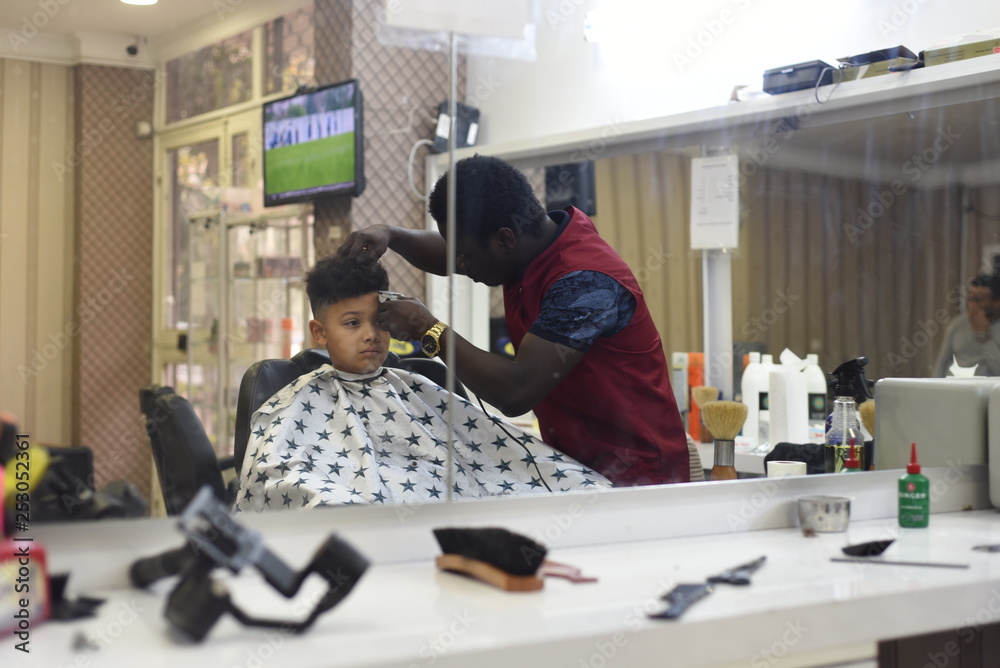 Cute african american boy in the african barbershop. Cute mixed boy ...