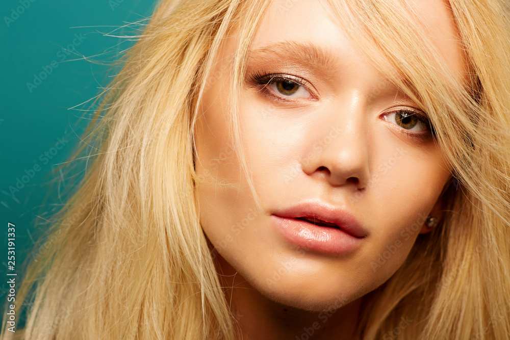 Beautiful face of a young woman with clean fresh skin isolated on light ...