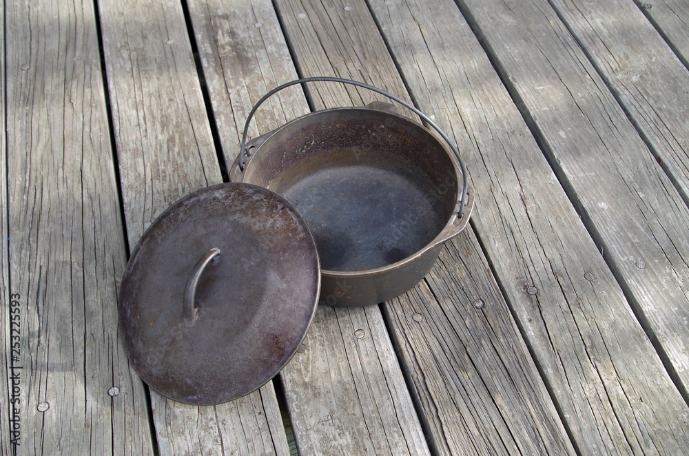 Large slightly rusted cast iron pot and lid Stock Photo | Adobe Stock