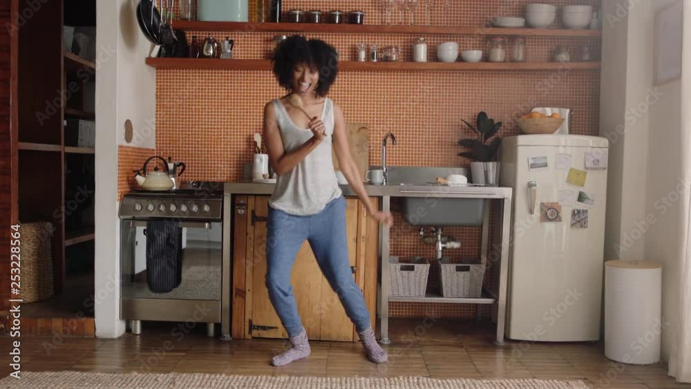 happy woman dancing in kitchen celebrating successful lifestyle ...