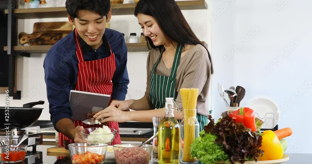 Lovely Asian Couple Cooking Meal Together Man Finds Recipe From Teblet