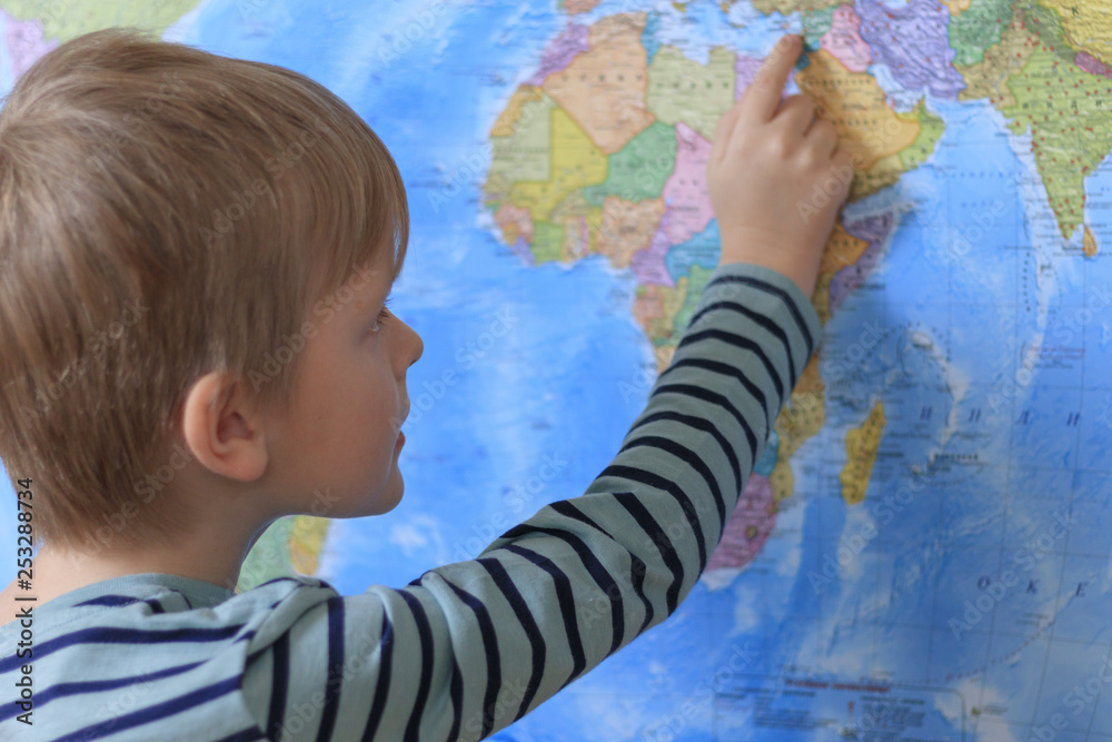 Beautiful kid measure distance on world map Stock Photo | Adobe Stock