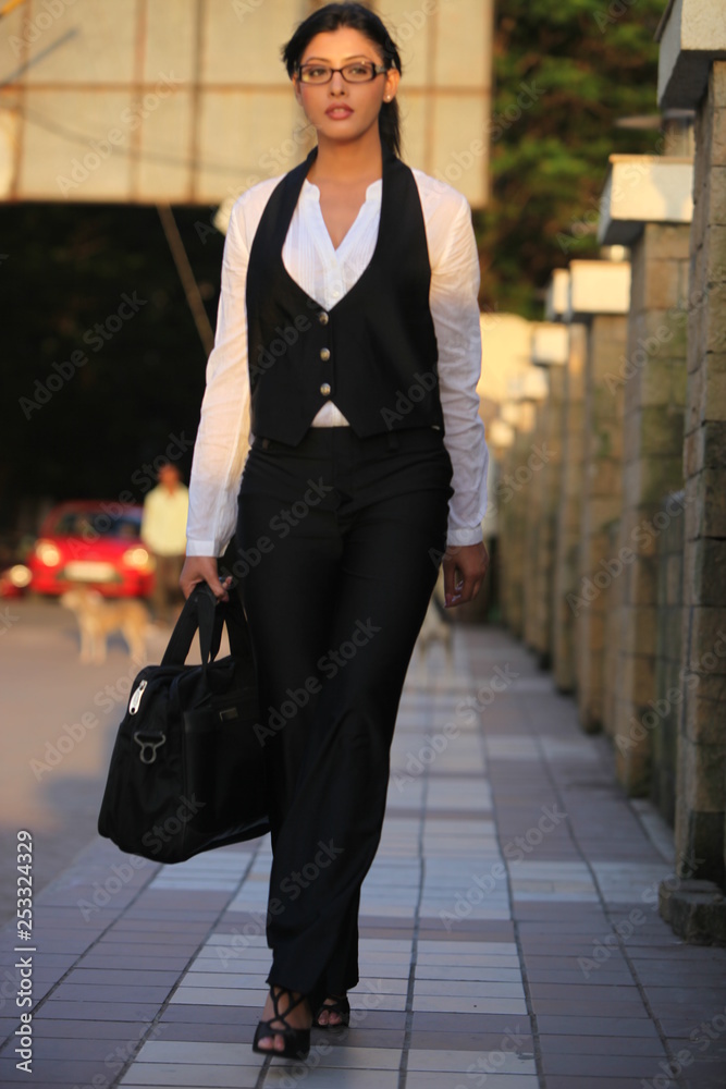 Beautiful business lady in corporate suit posing outdoor wearing ...