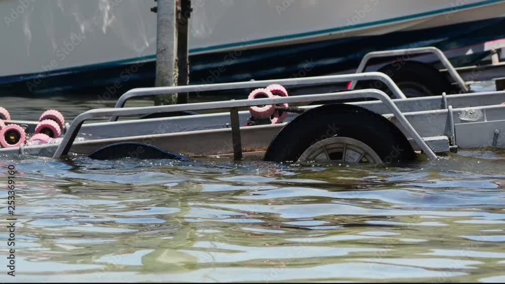 Empty boat trailer quickly reversed into the water at boat ramp Stock ...