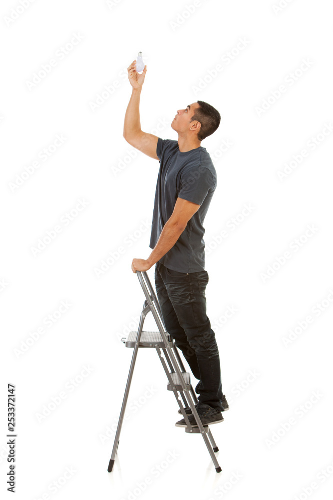 Man Climbing Stepladder To Replace Light Bulb Stock Photo | Adobe Stock
