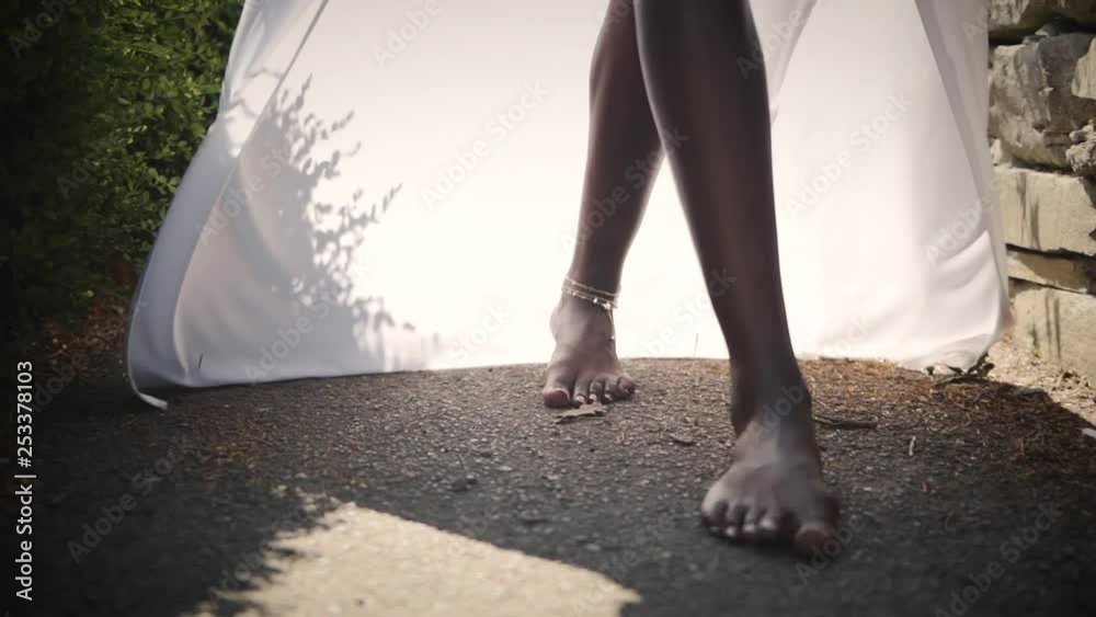 Beautiful African woman walking barefoot in a courtyard. Stock Video ...