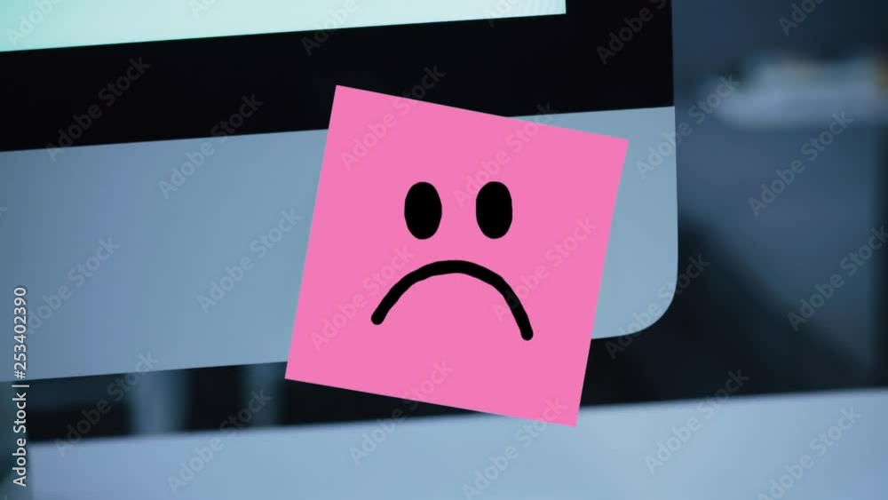 Sad smile. Sad face painted on a sticker on the monitor. Message ...