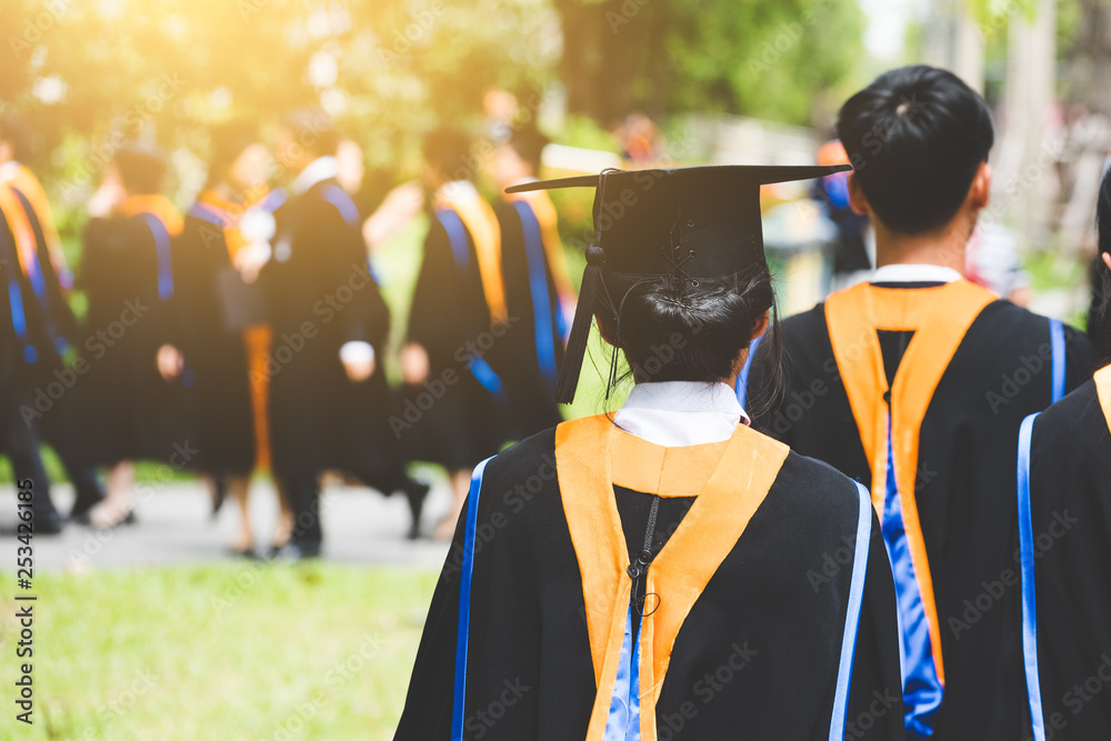 Education theme concept. Back view of Graduates during commencement ...