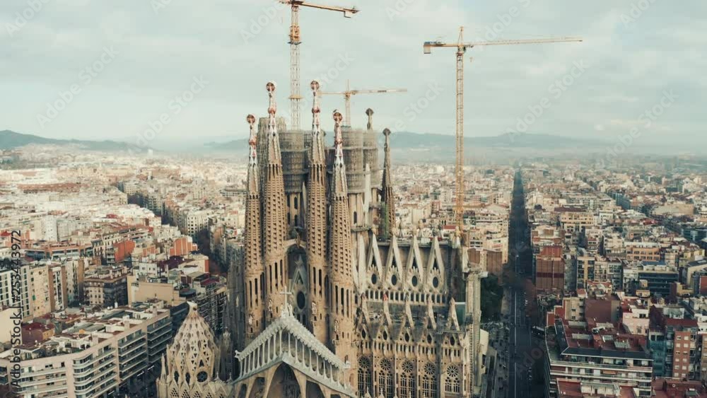 Aerial; drone view of main Gaudi project Sagrada Familia Temple; majestic building towering over ...