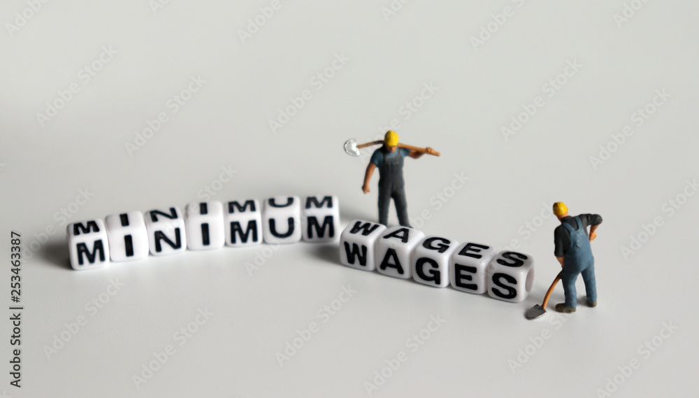 'MINIMUM WAGES' word in white cube. Miniature people. Stock Photo ...
