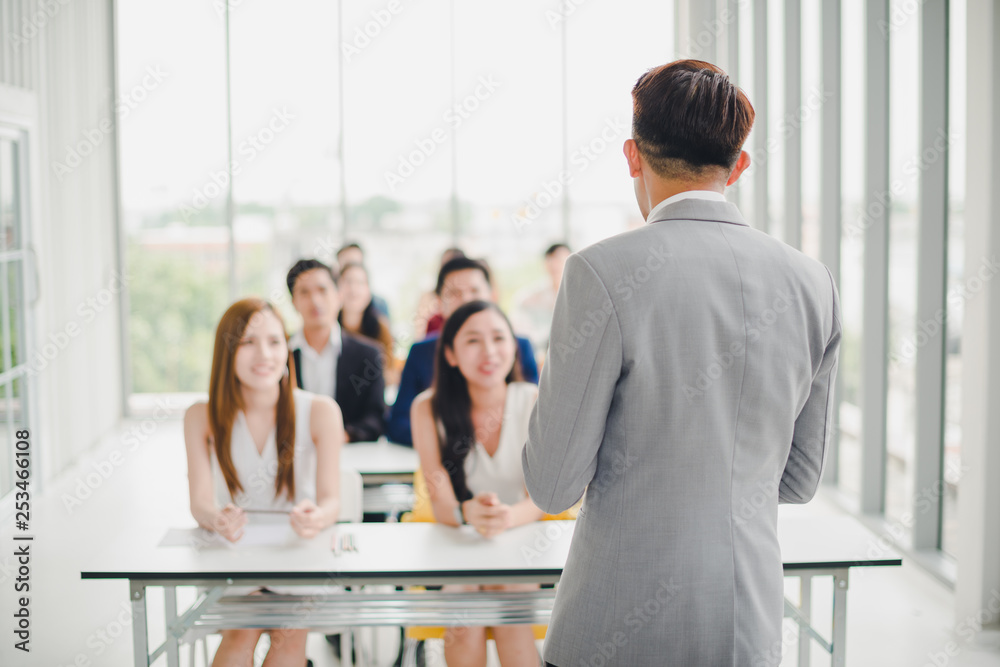 Asian male speaker is speaking at seminars and workshops to the people ...