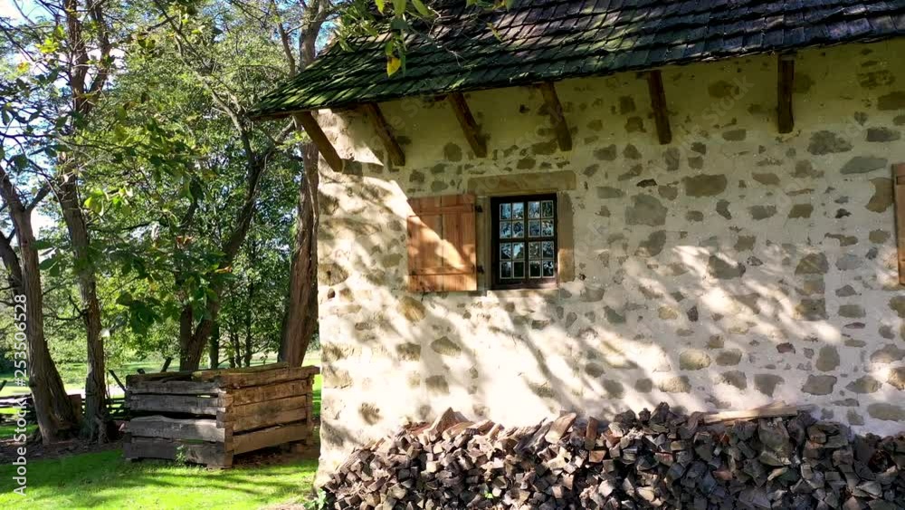 Aerial pan across Herr House building, a historic landmark, woodpile ...