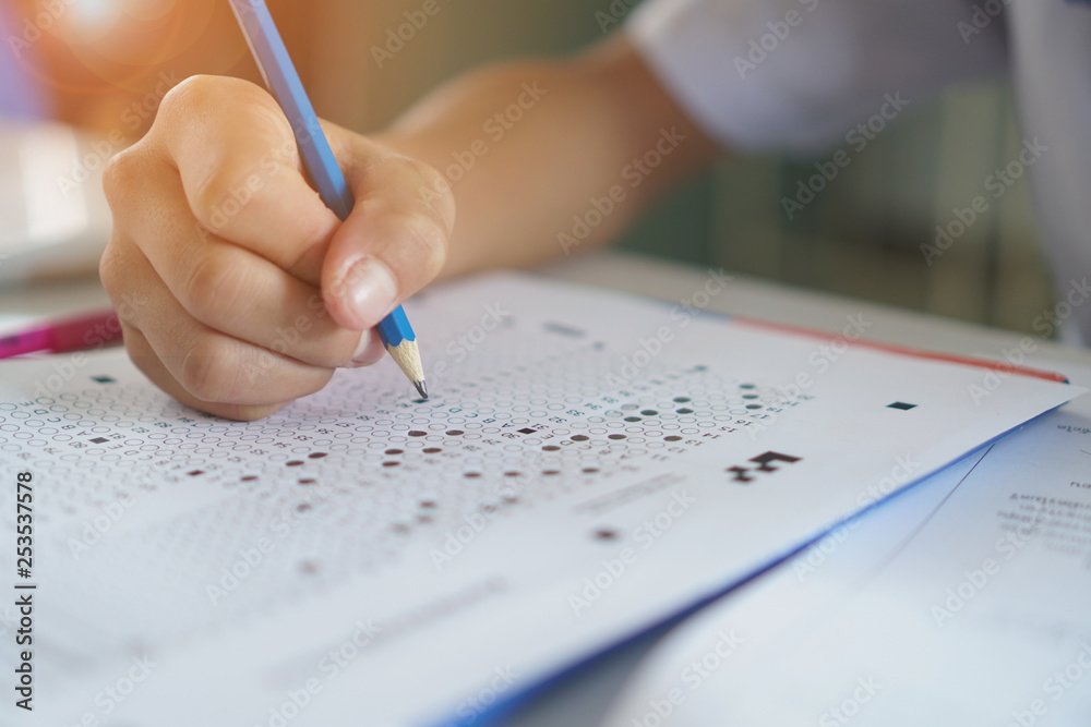 Answers to the questions.Students hand holding pencil writing selected ...