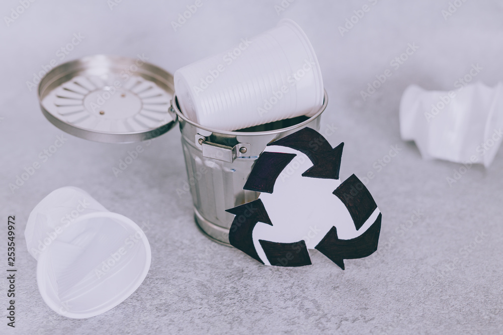 disposable cups and garbage bin with recycle symbol, concept of ...