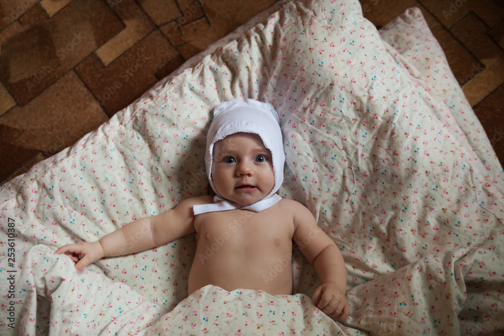 Naked child of three months lying on blanket. Stock Photo | Adobe Stock
