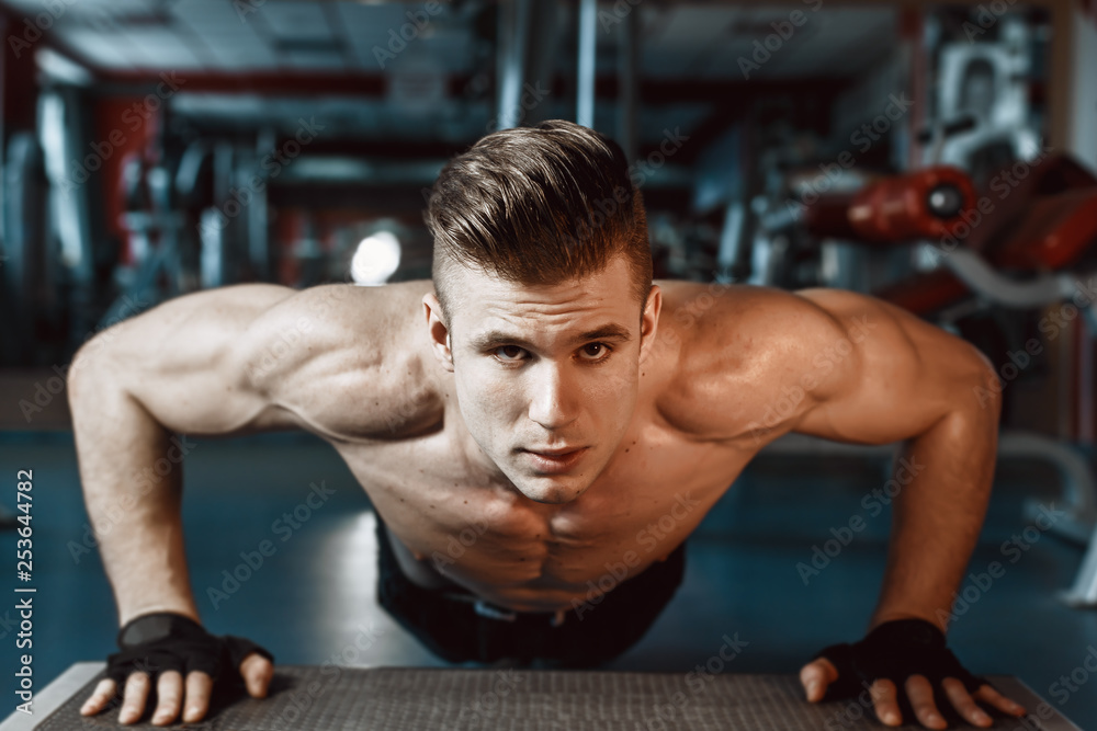 Muscular Model Young Man Exercising In Gym Portrait Of Sporty Strong