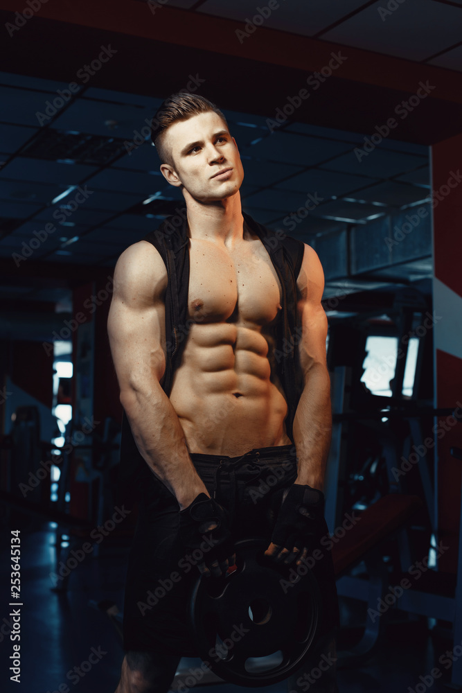 Muscular Model Young Man Exercising In Gym Portrait Of Sporty Strong