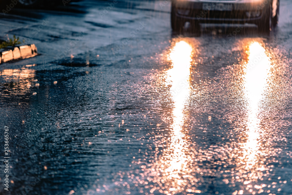 Night road blurred. Headlight of car in the dark while heavy raining ...