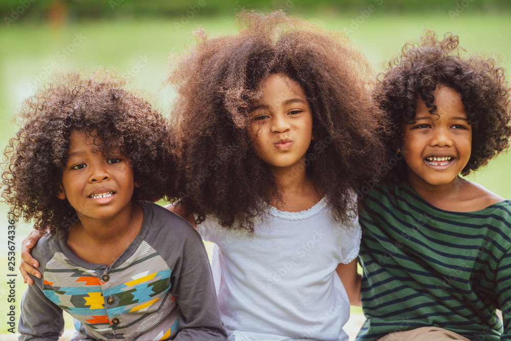 Happy African American boy and girl kids group playing in the ...