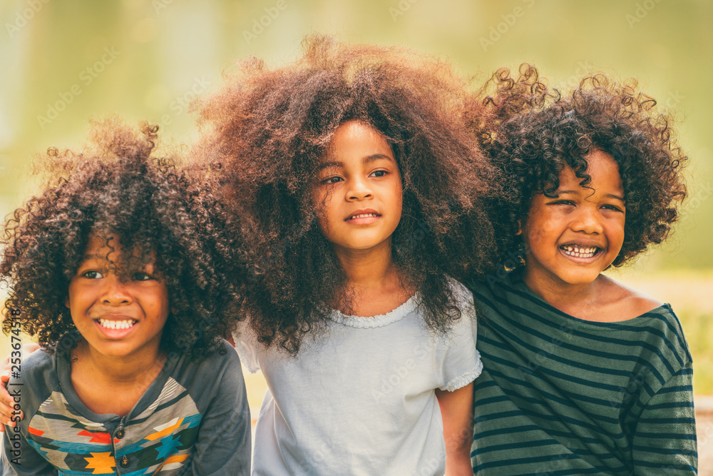Happy African American boy and girl kids group playing in the ...
