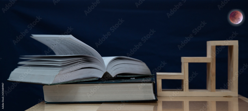 Textbook stack on wooden desk, with small wooden staircase step up to ...