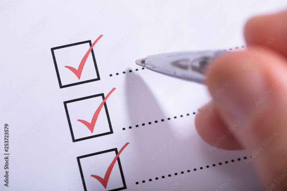 Person's Hand Marking On Checklist Stock Photo | Adobe Stock