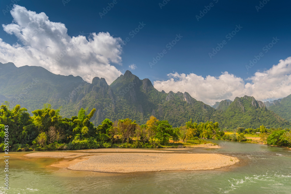 Rice field surrounded by rock formations in Vang Vieng, Laos. Vang ...