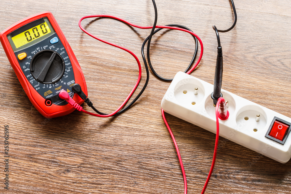 Measurement voltage in electrical socket with multimeter Stock Photo ...