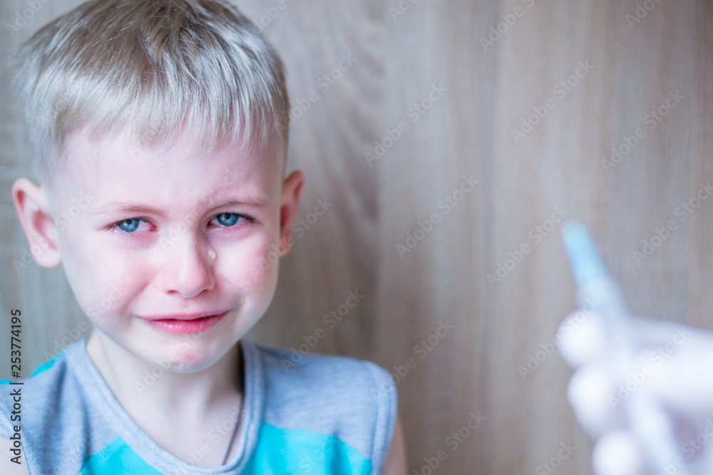 The boy is blond with blue eyes. He feels horror and despair. Very ...