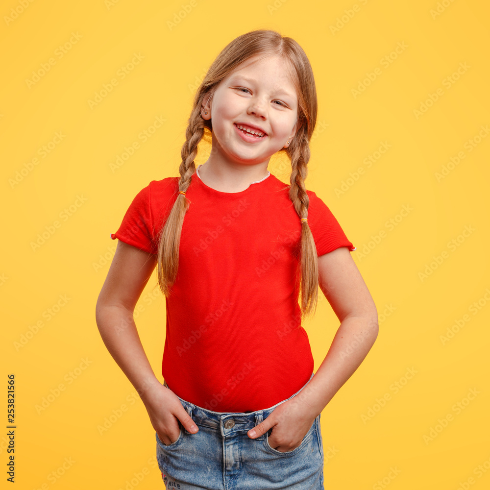 Cute little girl 5-6 years old posing and laughing in the studio on a ...