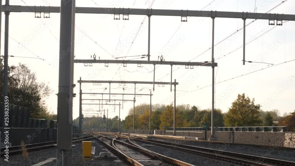 Overhead electrical wires on the tracks of the Nederlandse Spoorwegen. This is a Dutch state ...